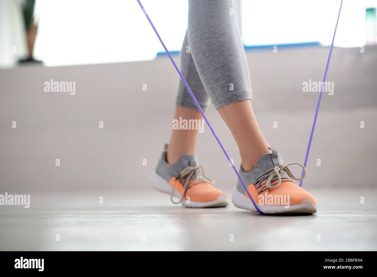 Female patient legs walking with jump rope Stock Photo - Alamy