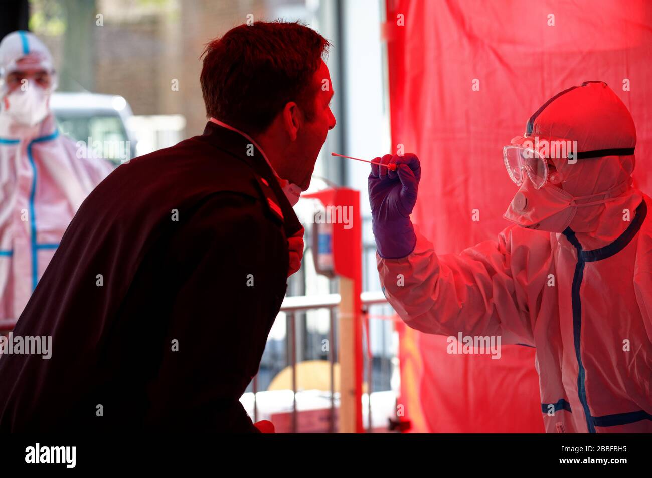 Cologne, Germany. 31st Mar, 2020. A member of the Cologne Fire Brigade ...