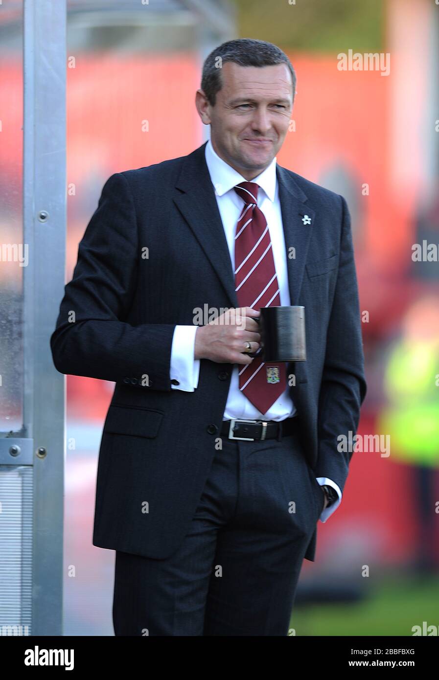 Northampton Town manager Adrian Boothroyd has a drink on the touchline ...