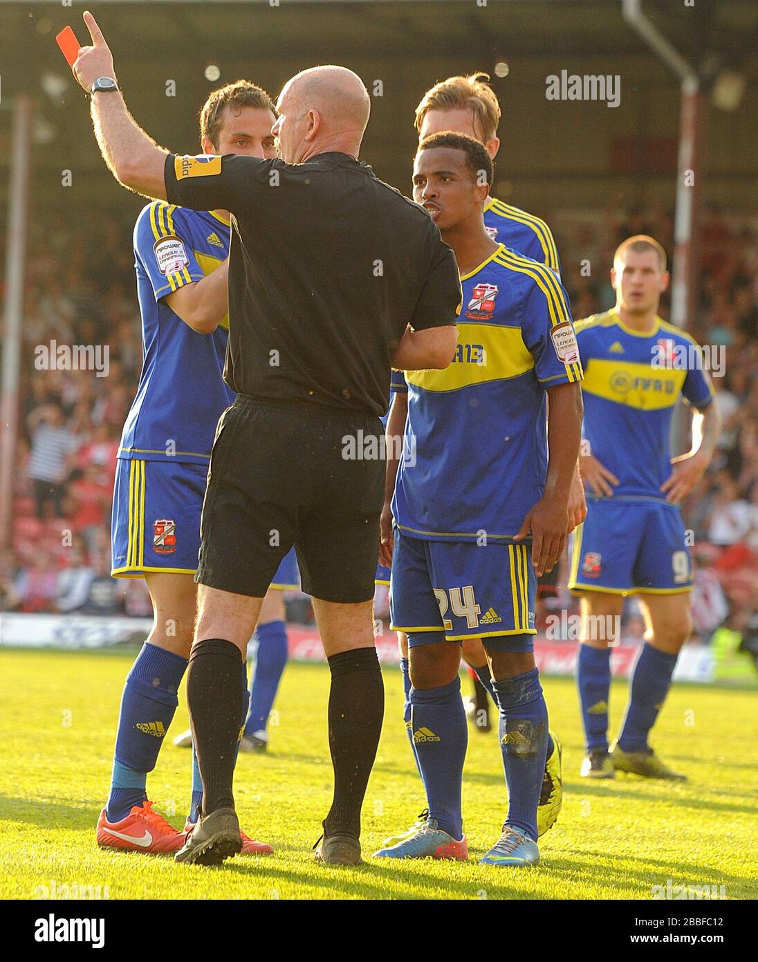 Swindon Town's Nathan Byrne (right) reacts as he is shown a red card by ...