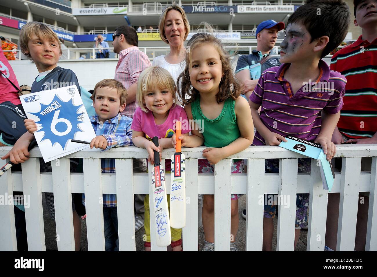 Surrey fans wait by the side of the pitch to get autographs from the ...