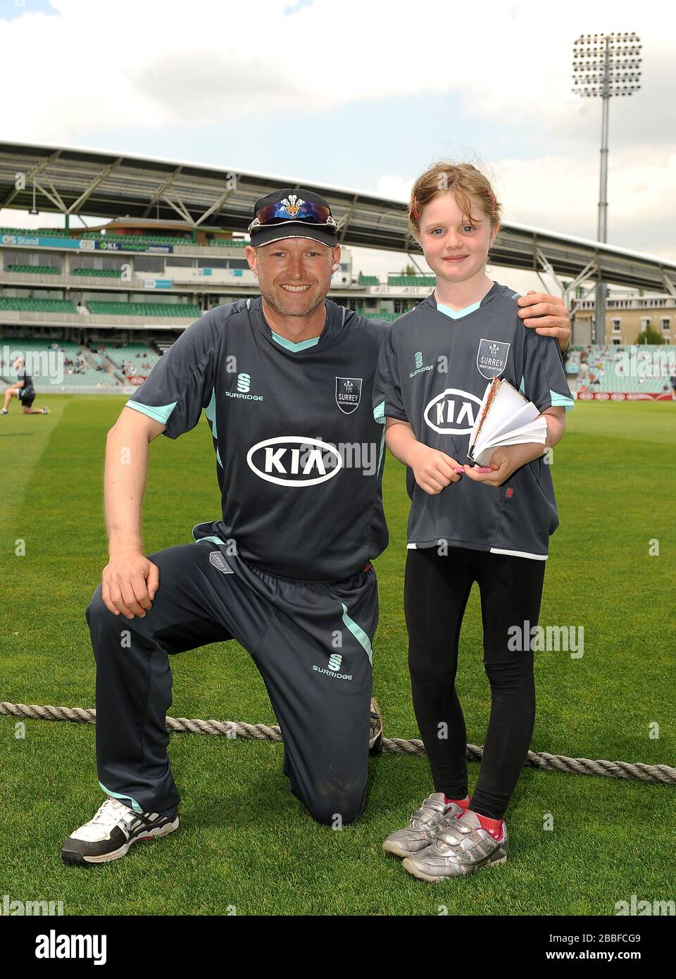 Surrey's Gary Keedy with the mascot for the day Stock Photo - Alamy