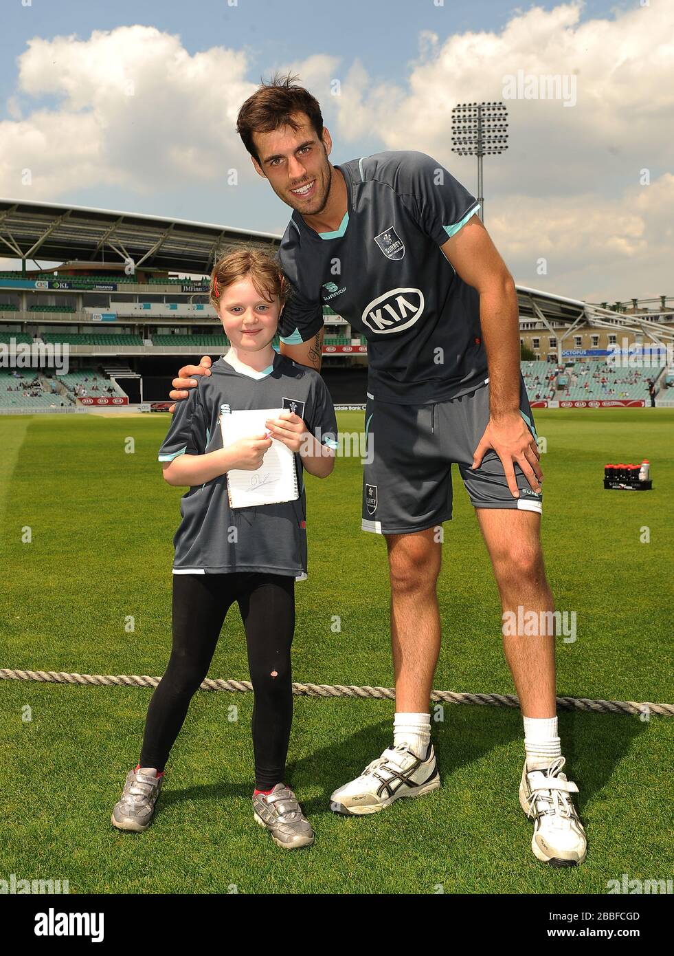 Surrey's Tom Jewell with the mascot for the day Stock Photo - Alamy