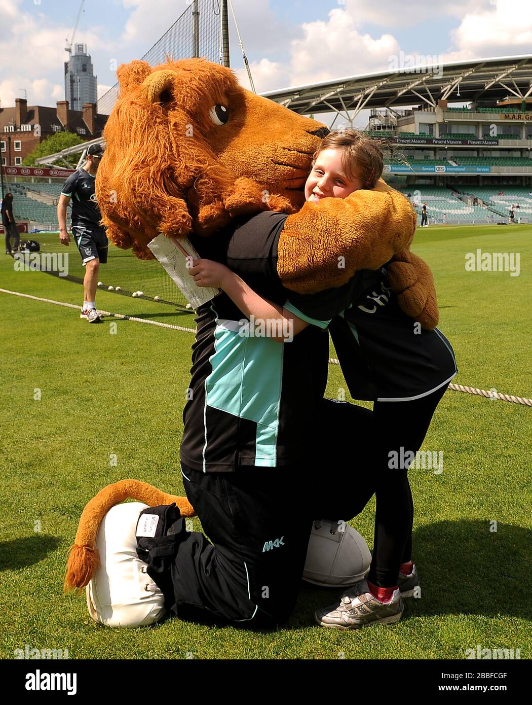 Surrey mascot Caesar the Lion with the young mascot for the day Stock ...