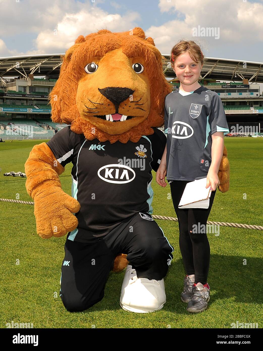 Surrey mascot Caesar the Lion with the young mascot for the day Stock ...