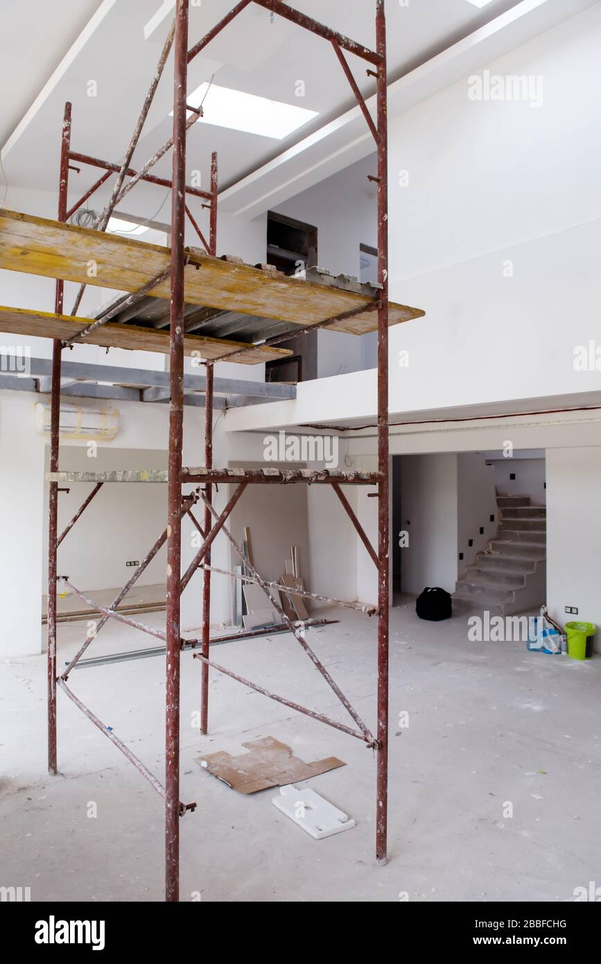 interior of construction site with scaffolding in a large modern ...