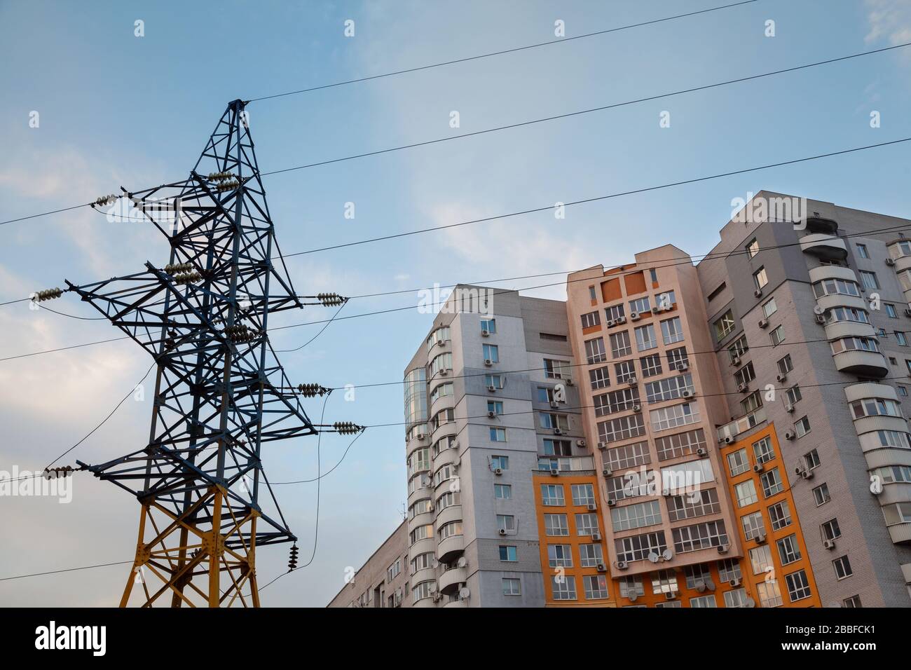 High-voltage networks, residential buildings against the evening sky ...
