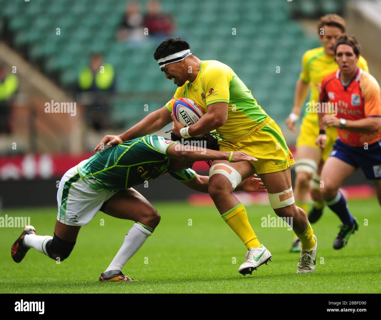 Australia's Jordan Tuapou is tackled by South Africa's Cecil Afrika ...