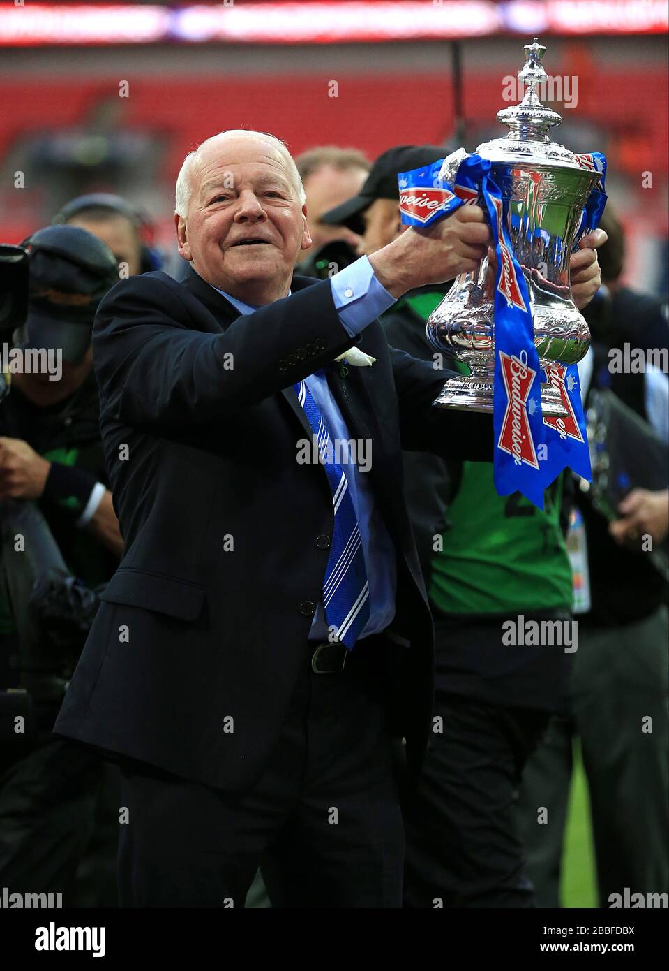Wigan Athletic Chairman Dave Whelan walks around the pitch carrying the ...