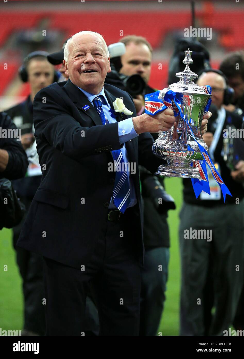 Wigan Athletic Chairman Dave Whelan walks around the pitch carrying the ...