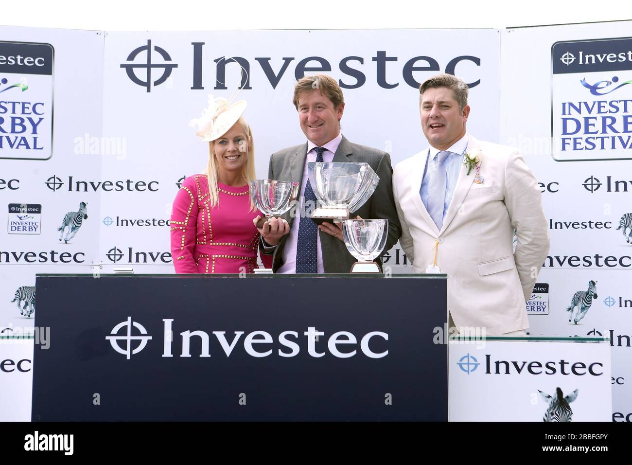 Trainer David Simcock (centre) after winning the Investec Mile with ...