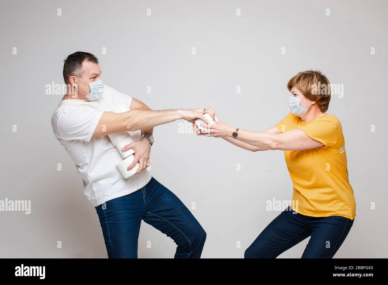 Nervous adult woman fighting with man over toilet paper Stock Photo - Alamy