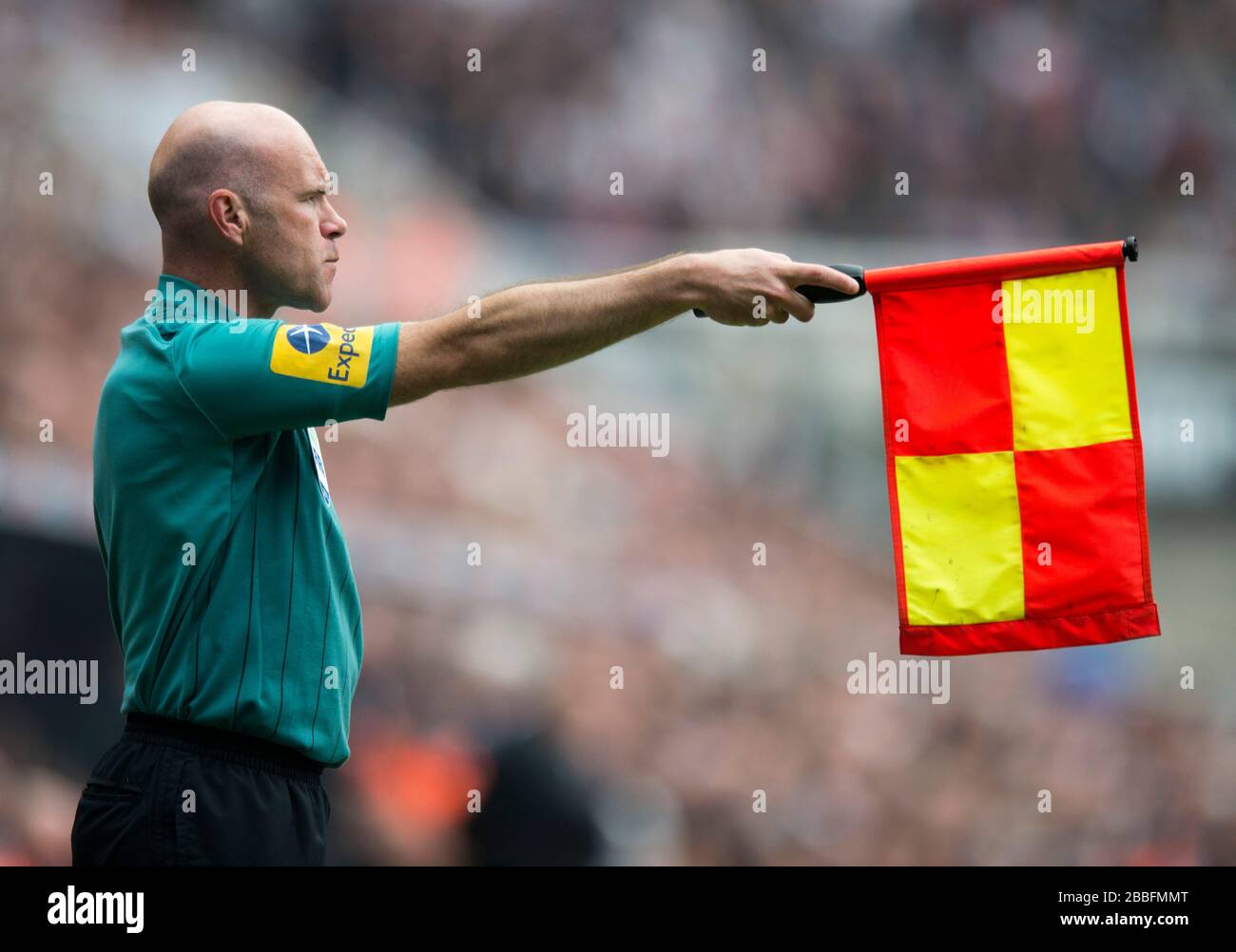 The assistant referee raises his flag on the touchline Stock Photo - Alamy