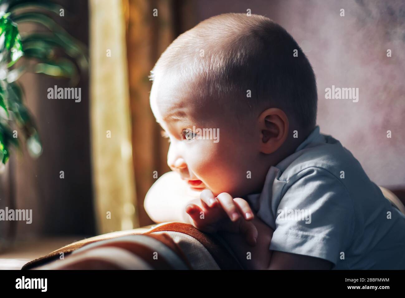 happy baby boy looking at window waiting Stock Photo - Alamy