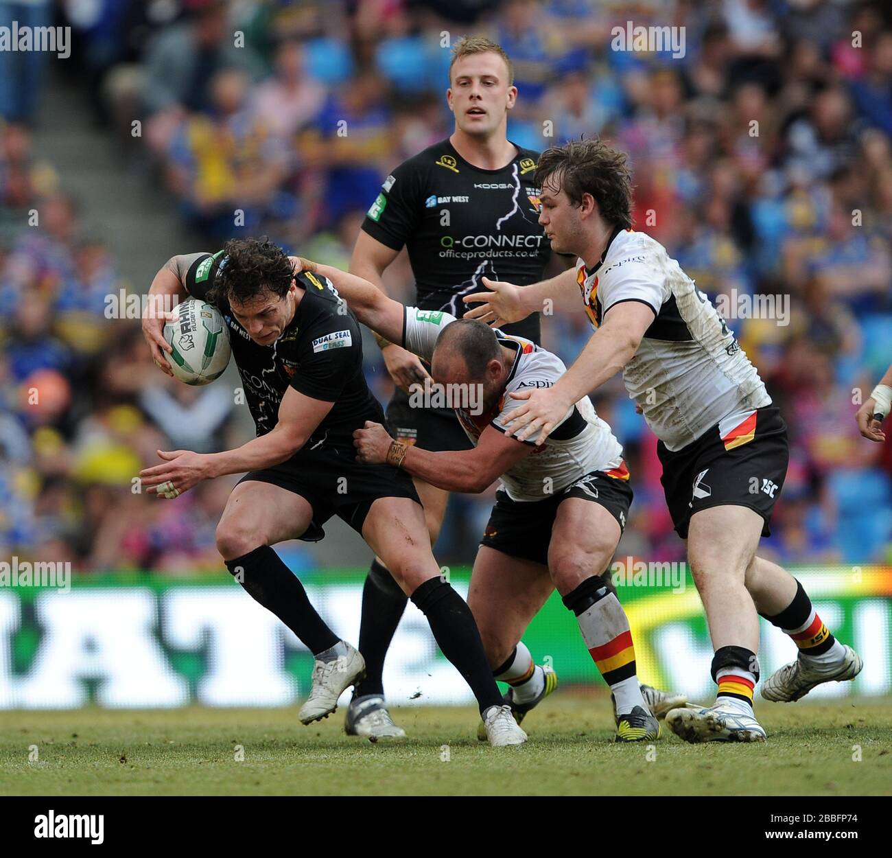Bradford Bulls' Jacob Fairbank (centre) tackles the Huddersfield Giants ...