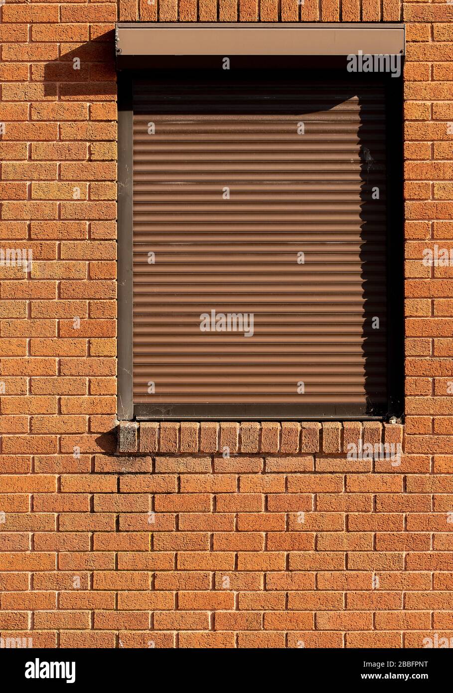 Industrial building exterior window with brown security shutter in ...