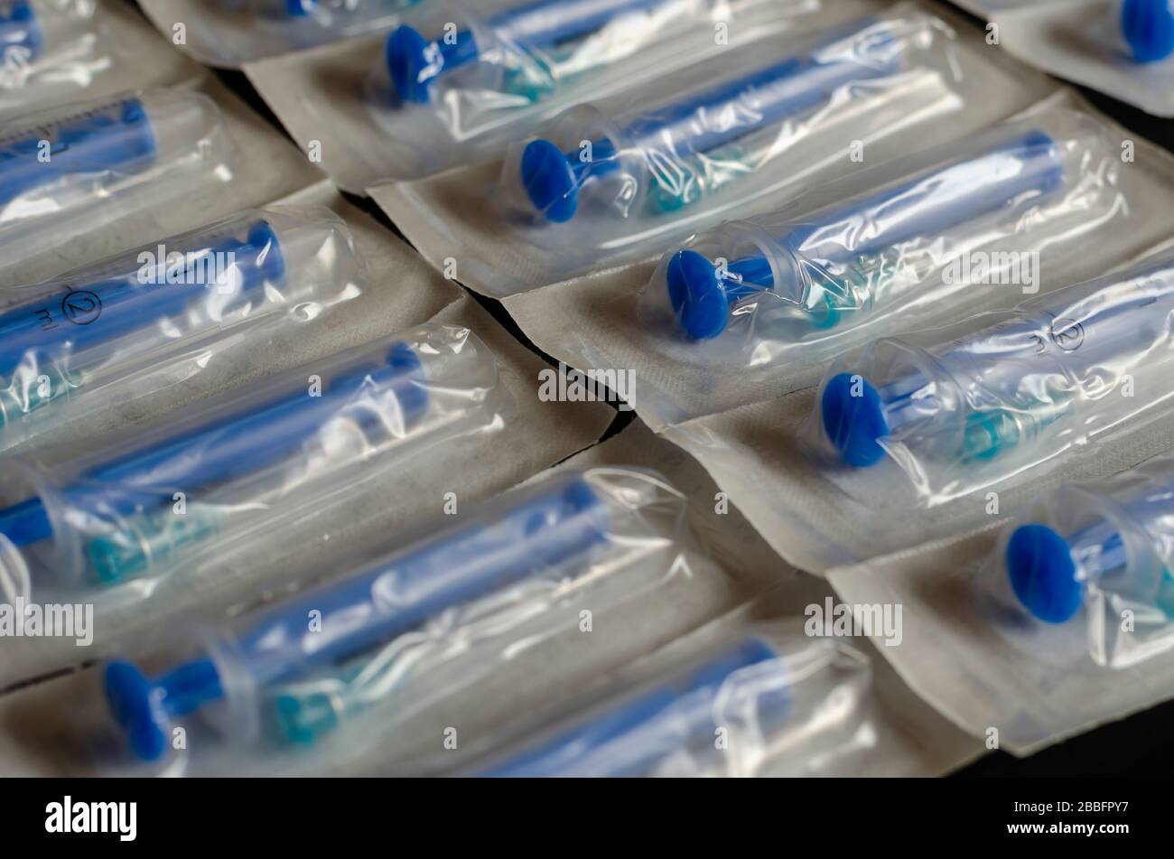 Group of new medical syringes. Blue Medical syringes in a package ...