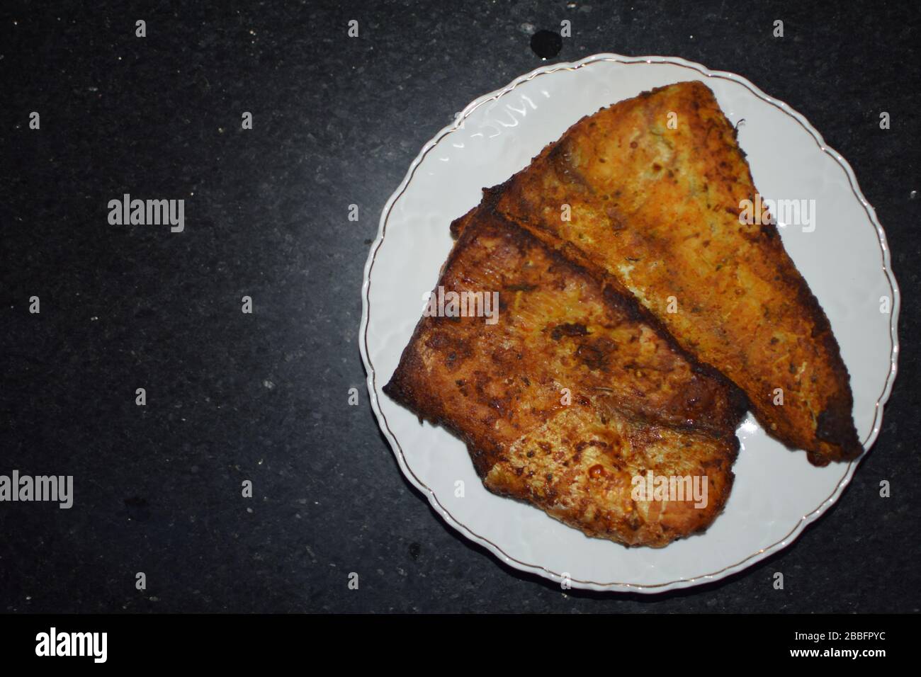 homemade baked spicy fish fillet with space to add text Stock Photo - Alamy