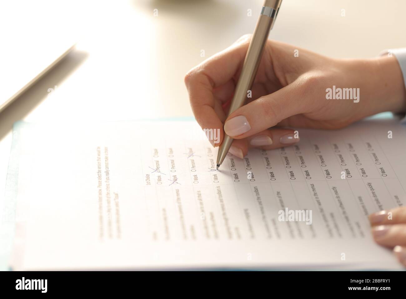 Close up of executive woman hand filling out form on a desk at the ...