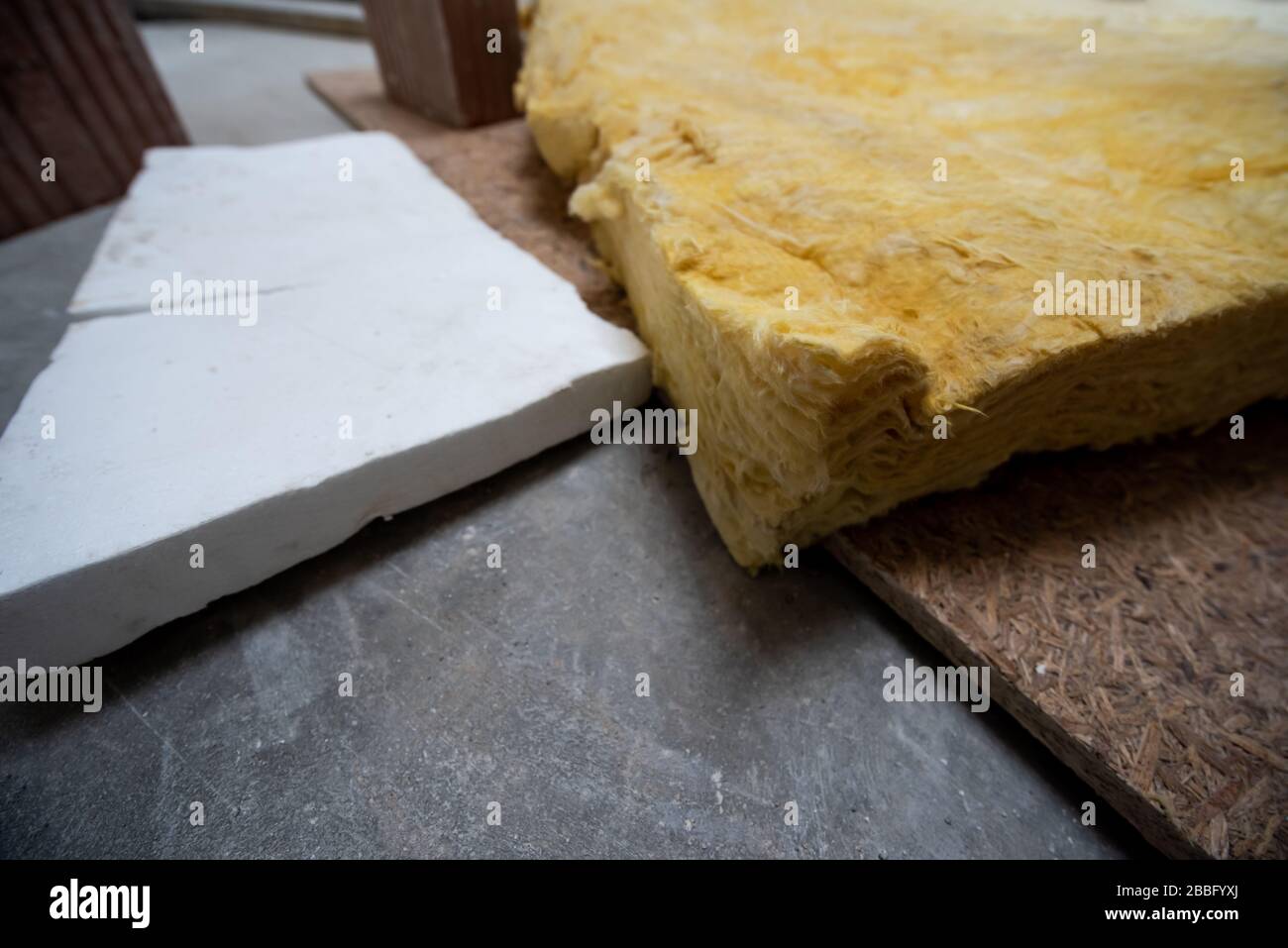 red Bricks and glass wool laying on the concrete floor at construction ...
