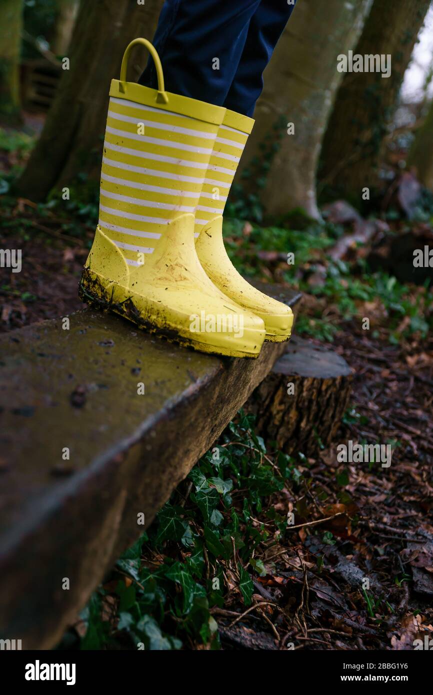 Child wearing wellies playing on an activity trail Stock Photo - Alamy