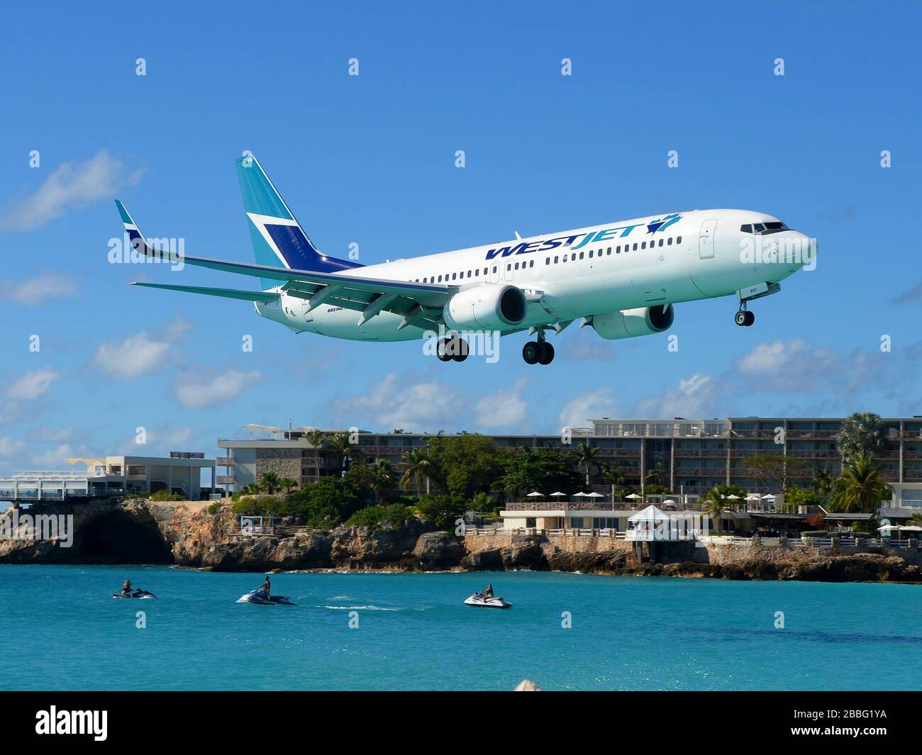 WestJet Airlines Boeing 737 passing over Maho Beach, a popular tourist ...