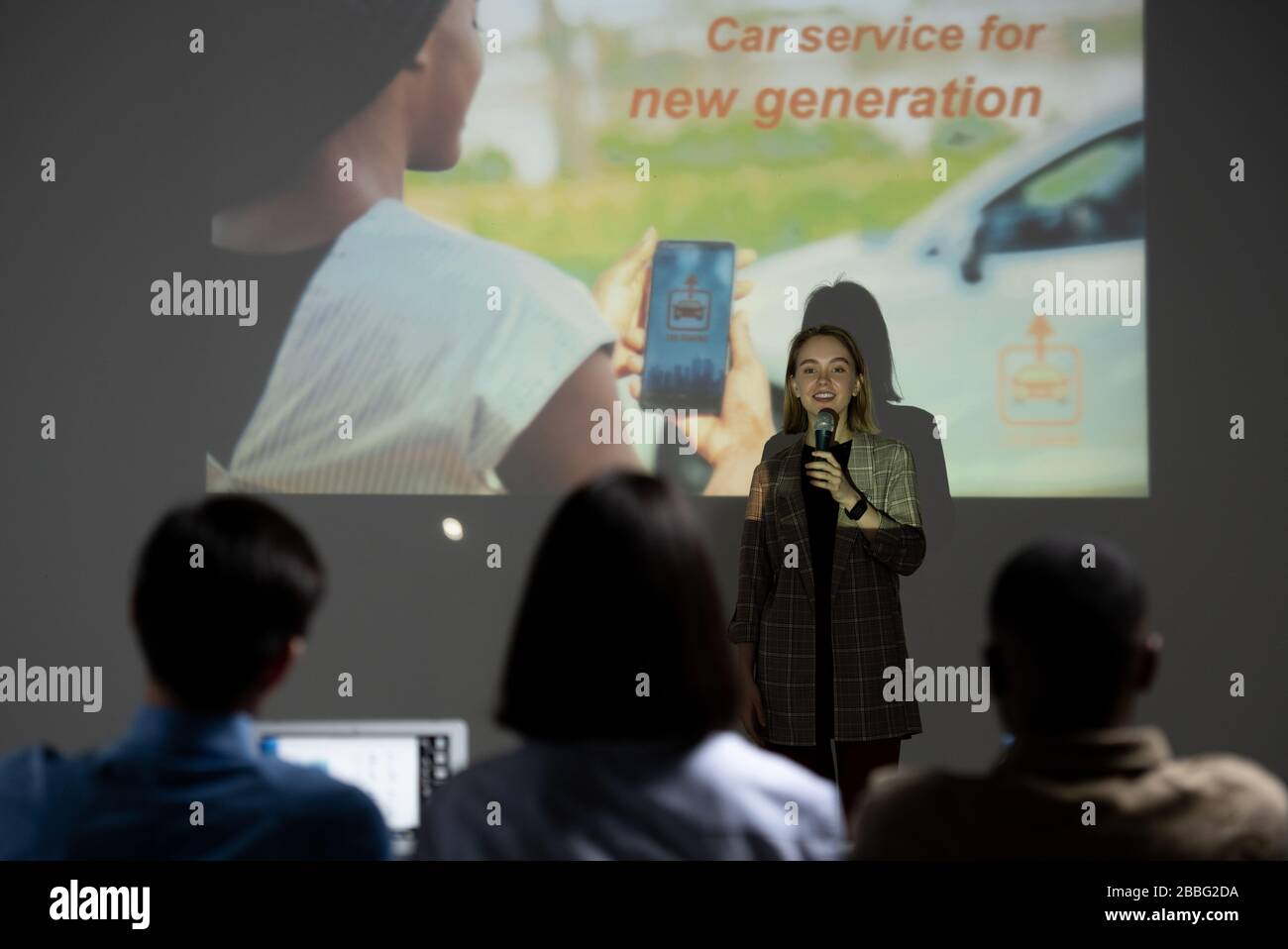 Woman speaking into microphone hi-res stock photography and images - Alamy