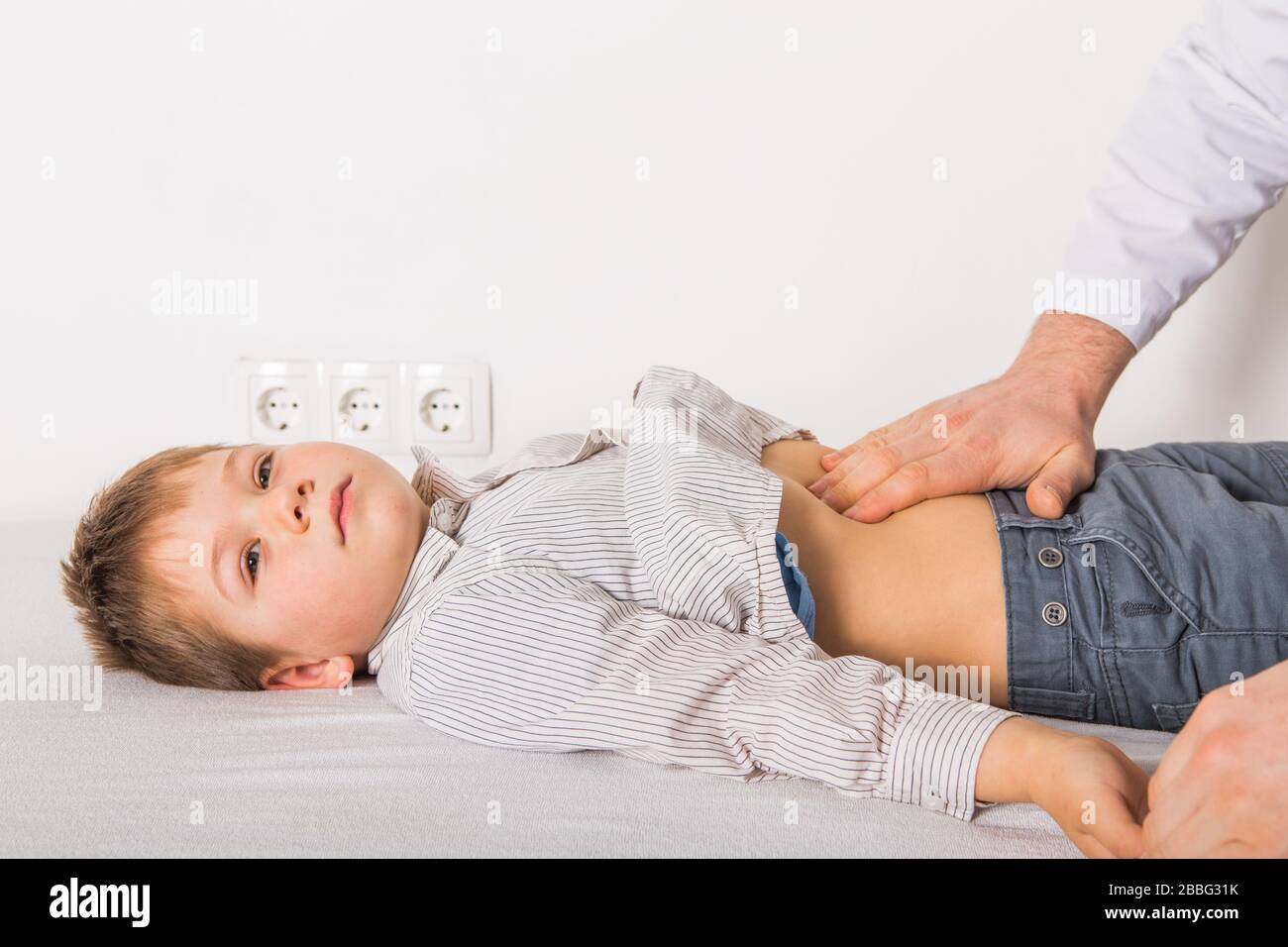 The doctor examines the belly child at clinic Stock Photo - Alamy