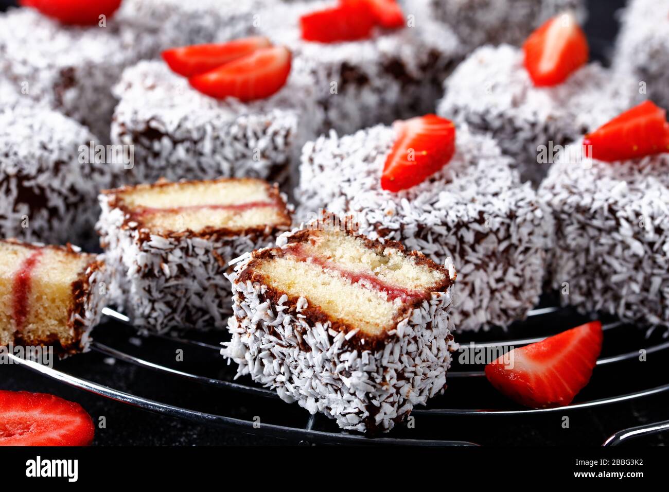Traditional vanilla sponge mini cakes with strawberry jam layer inside ...