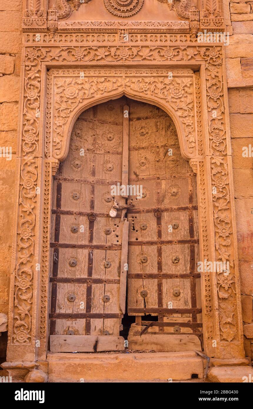 Beautiful carving details on yellow sandstone frame gate and abandoned ...
