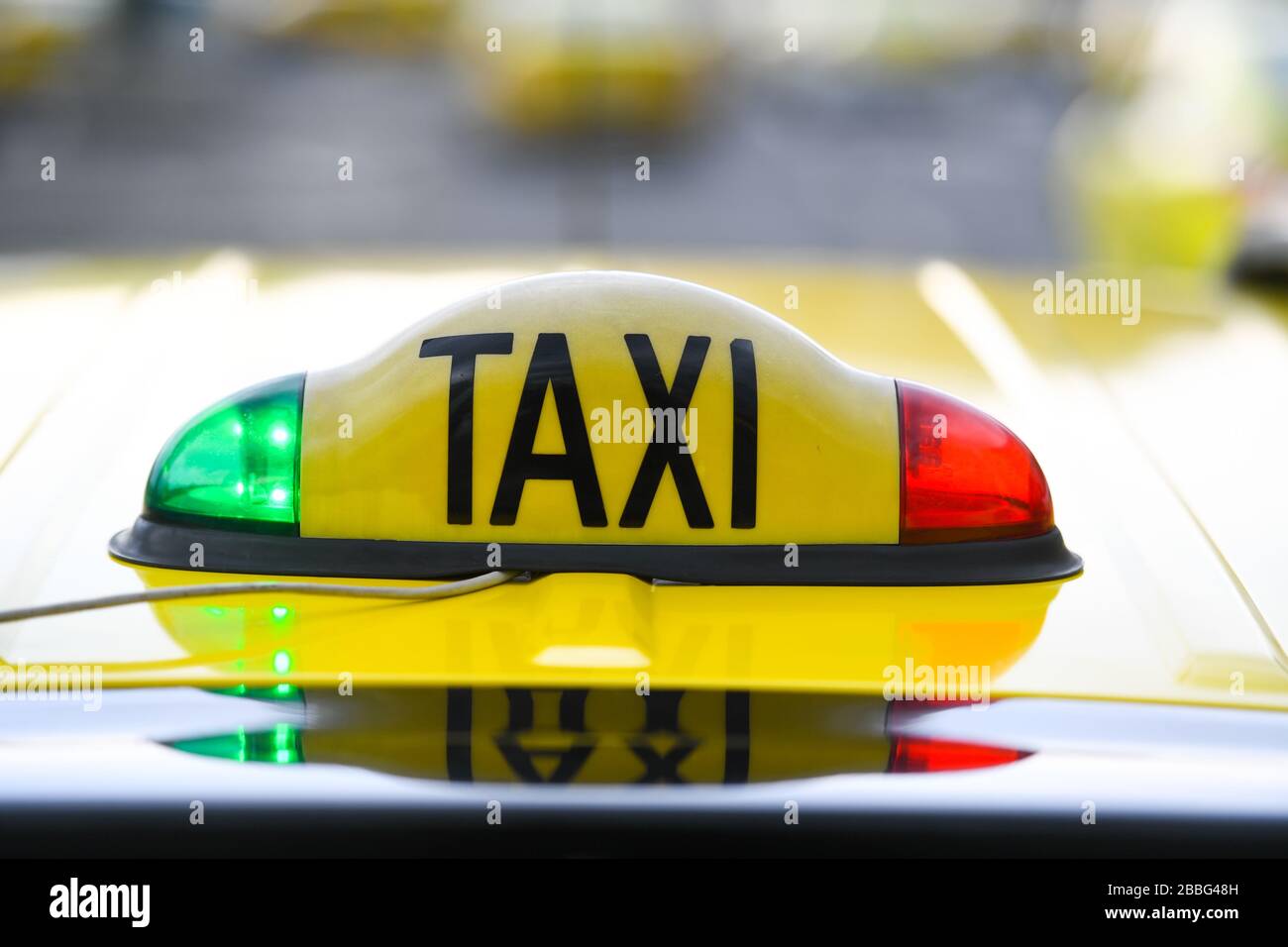 Taxi sign with red and green lights on the roof Stock Photo - Alamy