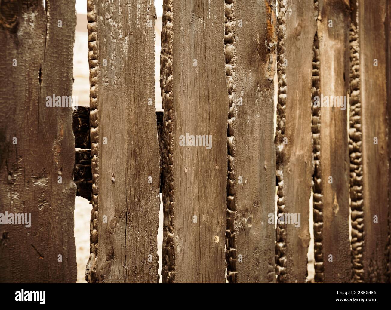 Burnt fence boards after a fire in a private house. The consequences of ...