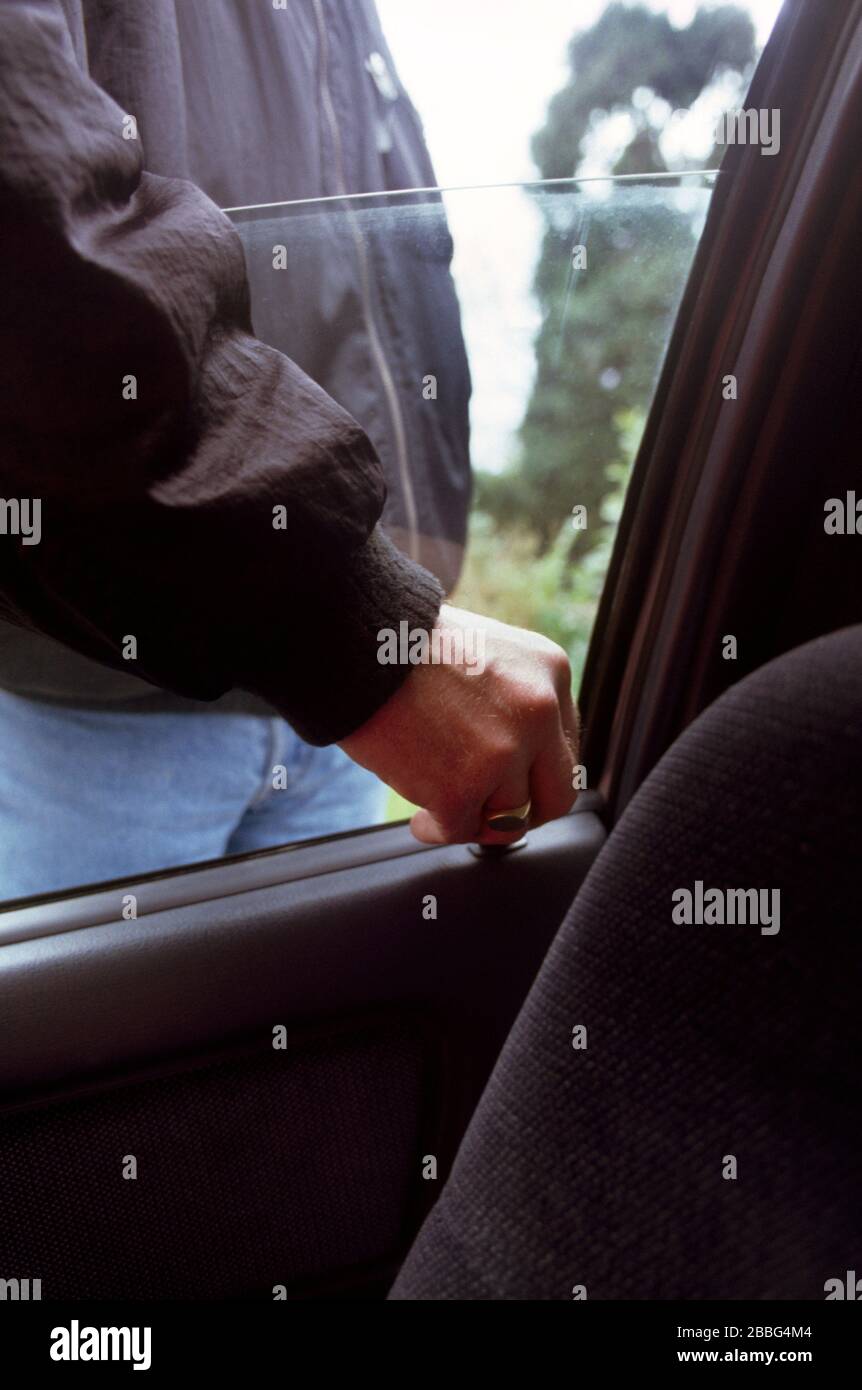 Car Theft Hand Reaching Through Open Car Window Unlocking Door Stock ...