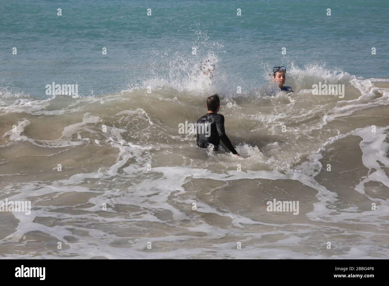 Grand Anse Beach Grenada men swimming in the sea Stock Photo - Alamy