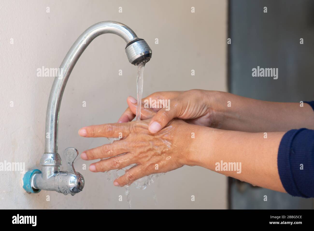 Muslim women wash hand with soap alcohol gel for sanitizer in kitchen ...