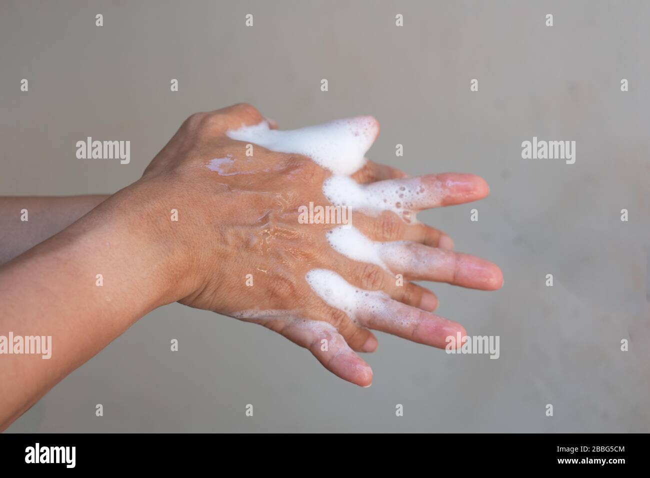 Muslim women wash hand with soap alcohol gel for sanitizer in kitchen ...