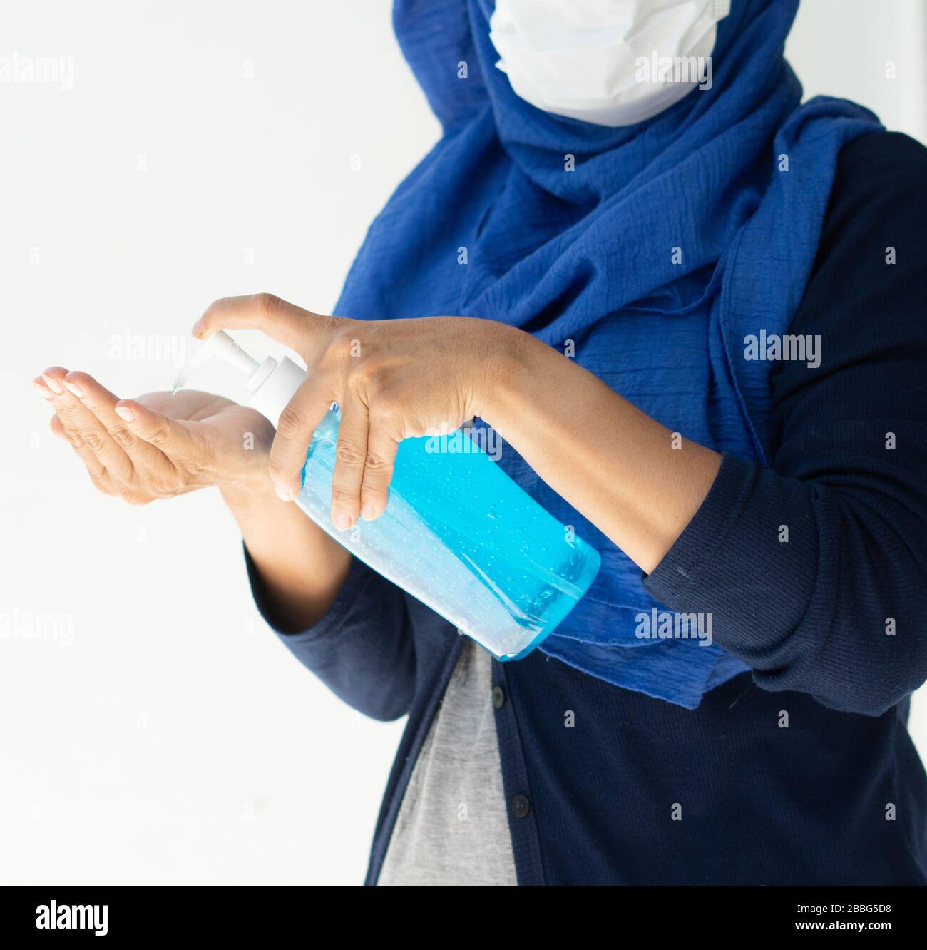 Muslim women wash hand with soap alcohol gel for sanitizer in kitchen ...