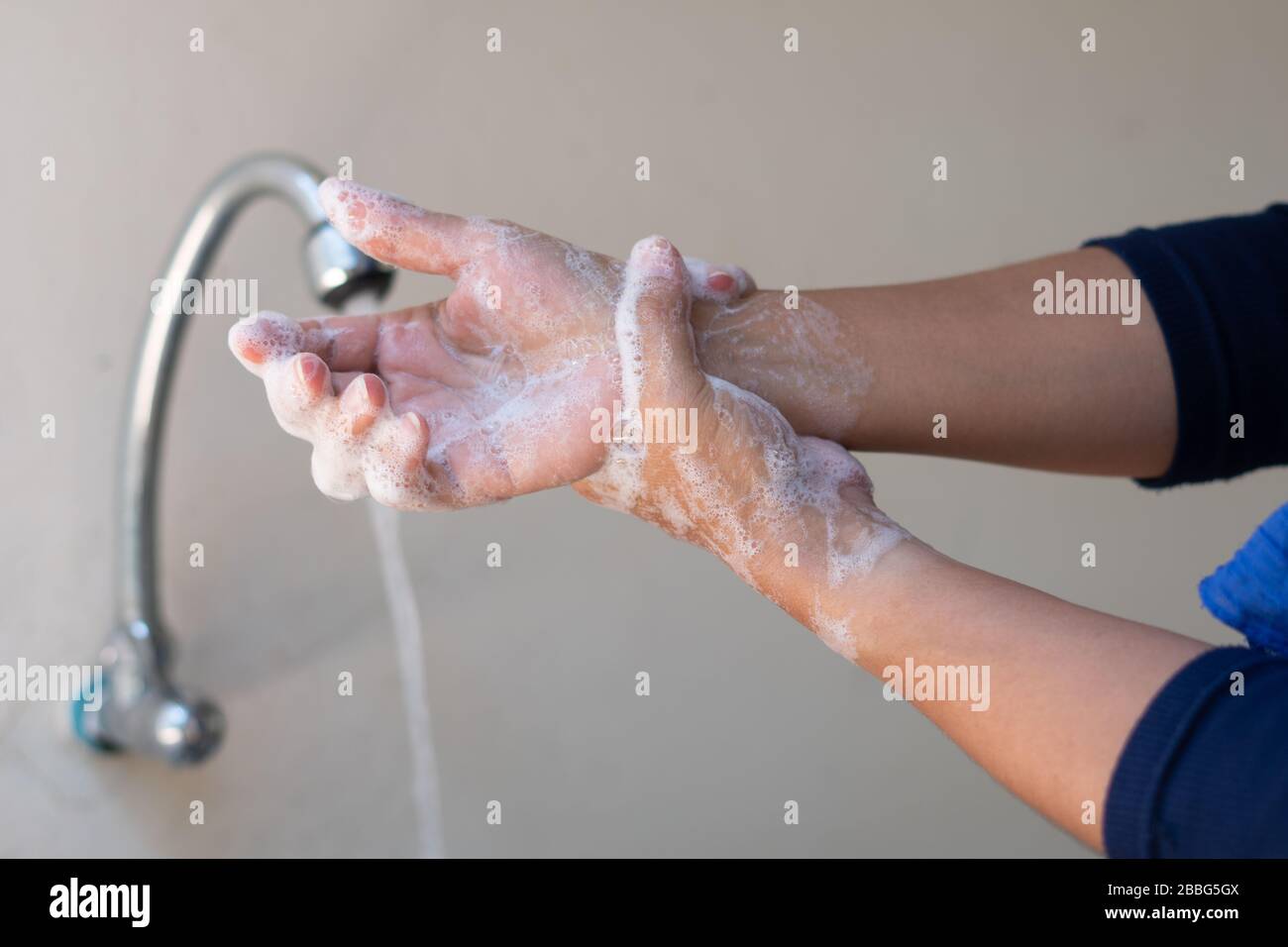Muslim women wash hand with soap alcohol gel for sanitizer in kitchen ...