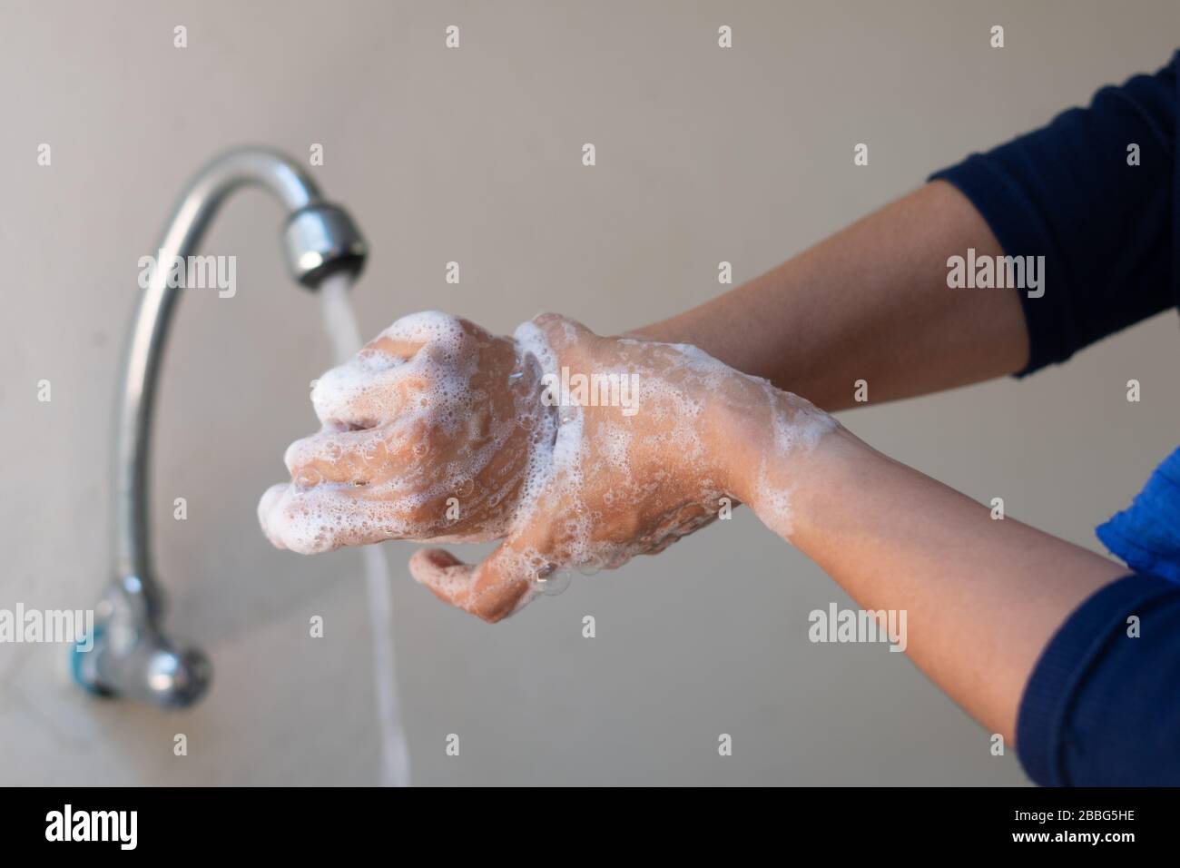Muslim women wash hand with soap alcohol gel for sanitizer in kitchen ...