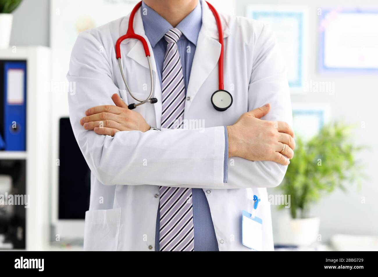 Male medicine doctor hands crossed on his chest Stock Photo - Alamy