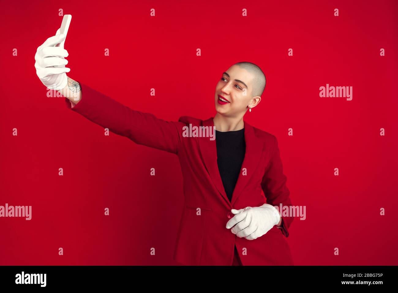 Taking selfie or vlog. Portrait of young caucasian bald woman isolated ...