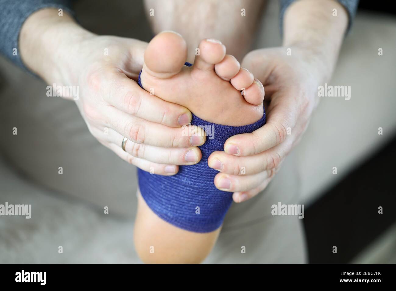 Human holding foot with hand Stock Photo - Alamy