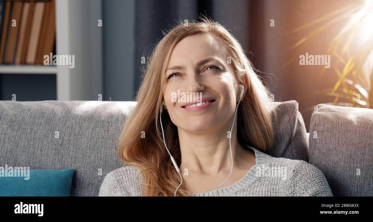 Woman listening to music headshot Stock Photo - Alamy
