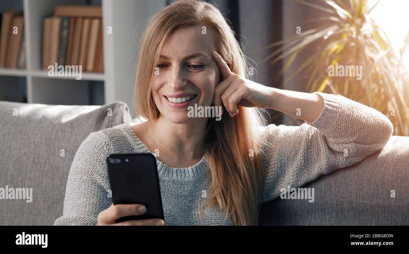 Happy woman using cellphone Stock Photo - Alamy