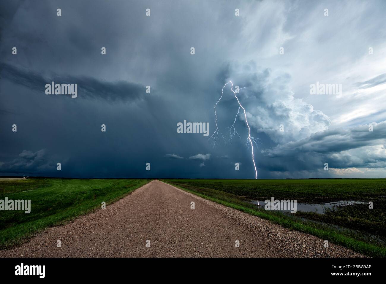Storm with lightning flashing on rural gravel road in southern Manitoba ...
