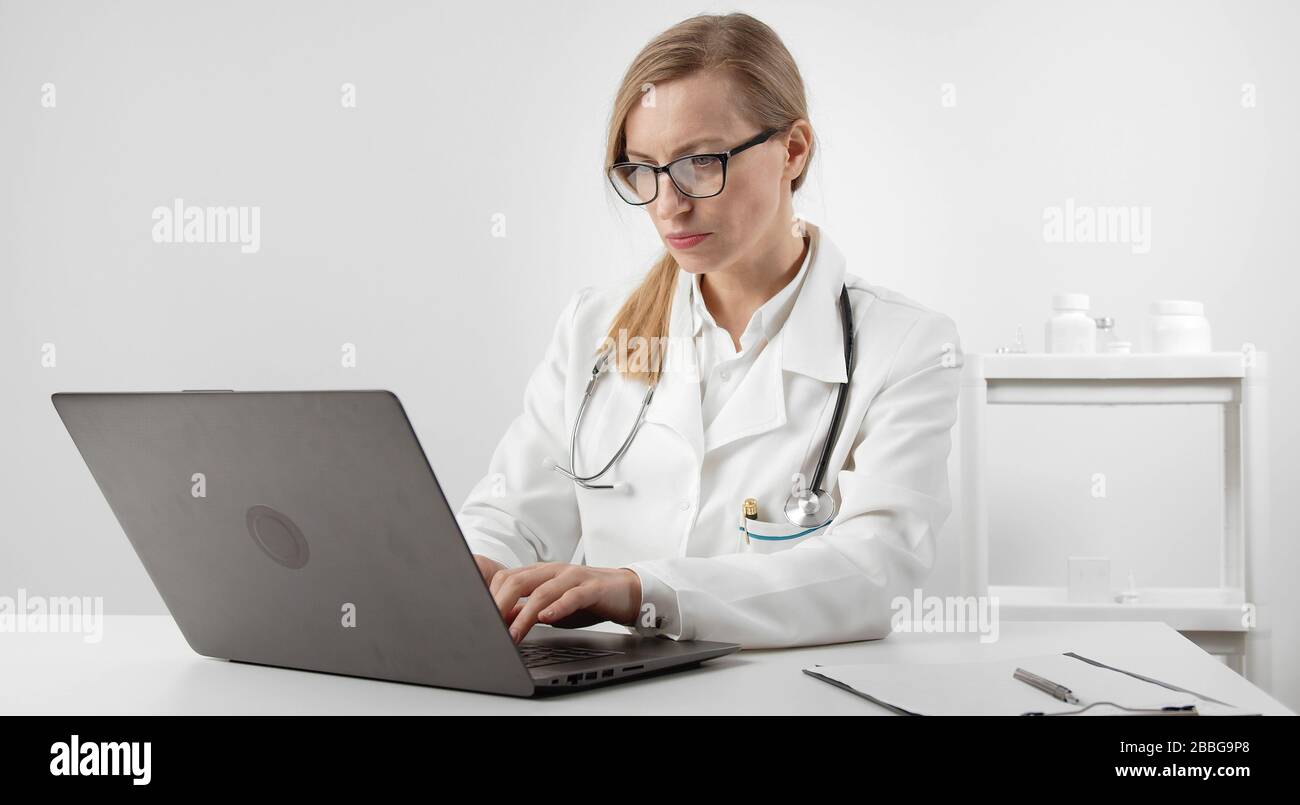 Female doctor using computer typing hi-res stock photography and images ...