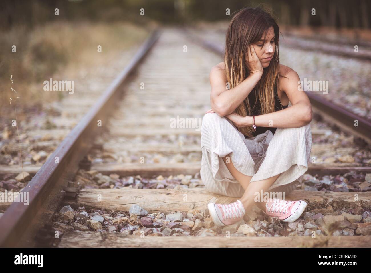 Sad girl on railway hi-res stock photography and images - Alamy
