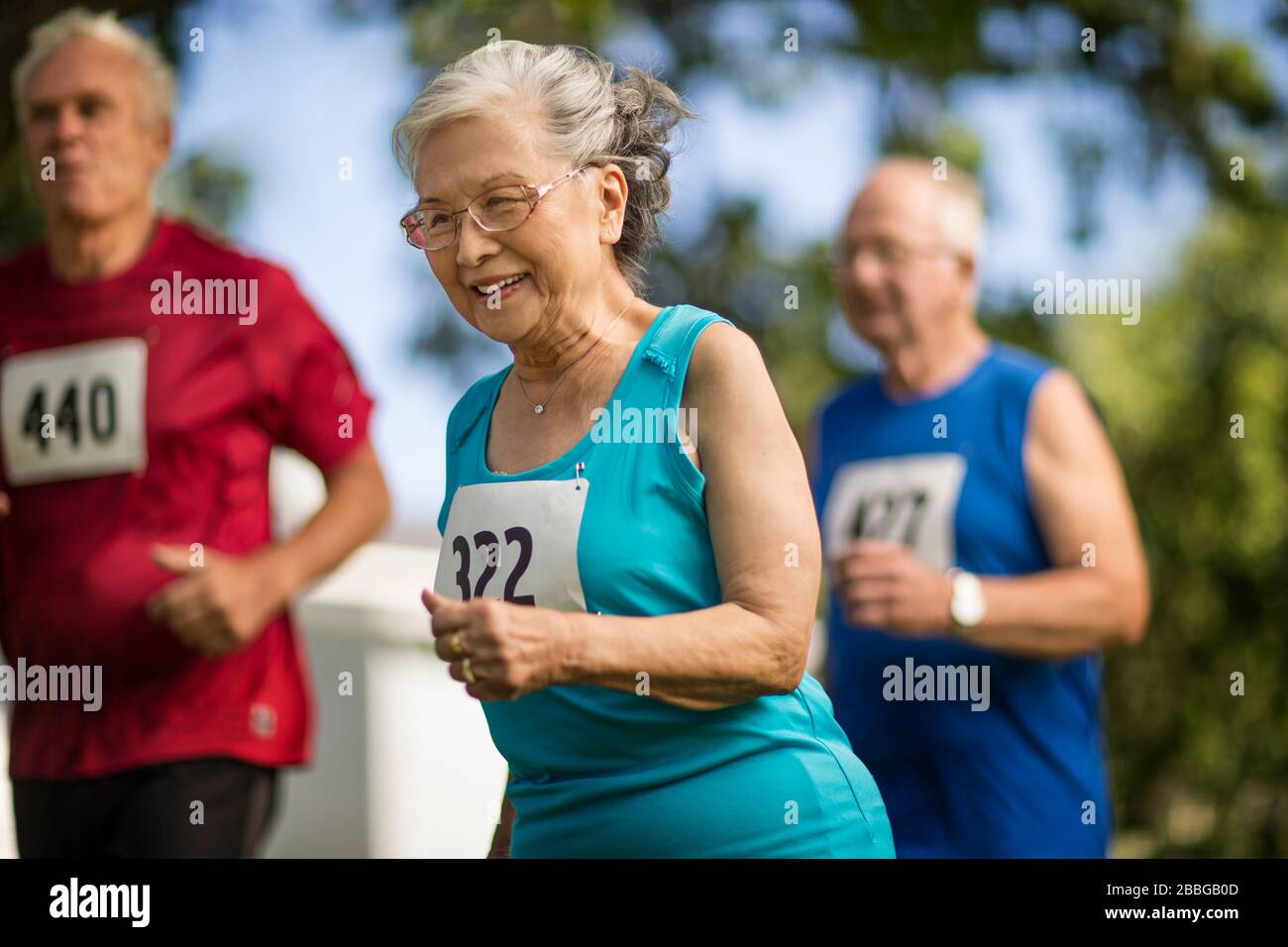 Senior woman running in a race at an athletics event Stock Photo - Alamy