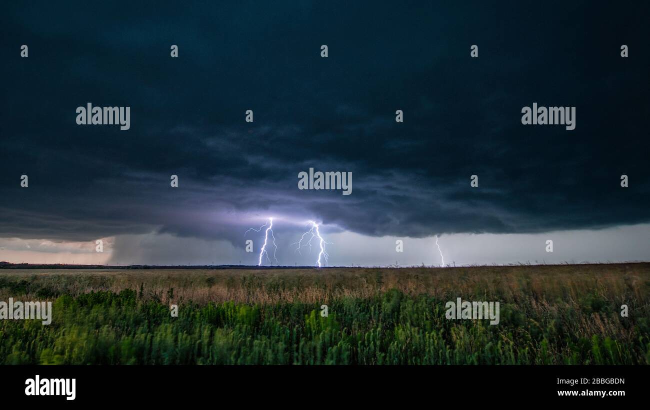 Storm with lightning flashing over wheat field in Texas United States ...