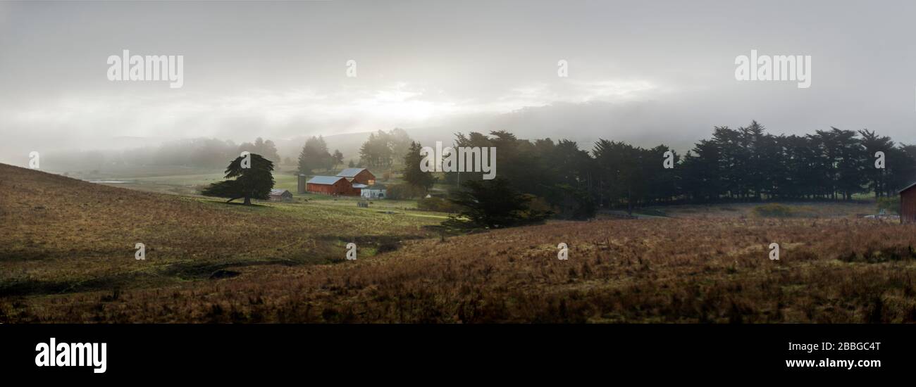 Farm under a cloudy sky Stock Photo - Alamy